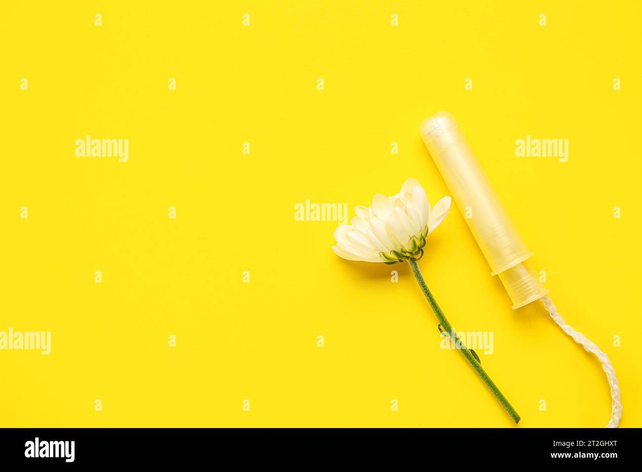 Menstrual tampon and chamomile flower on yellow background Stock Photo ...