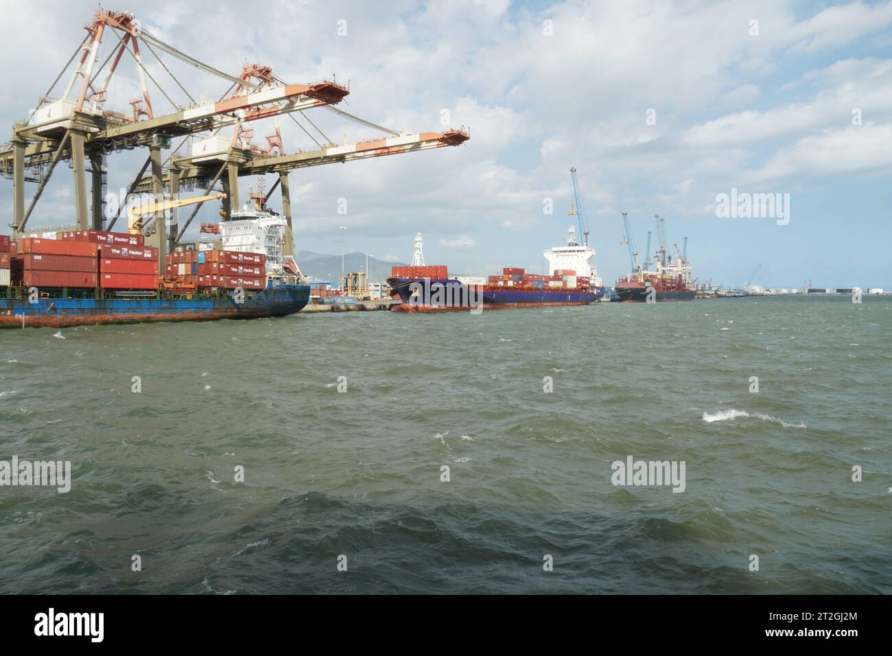 Container vessels under gantry cranes during cargo operation in ...
