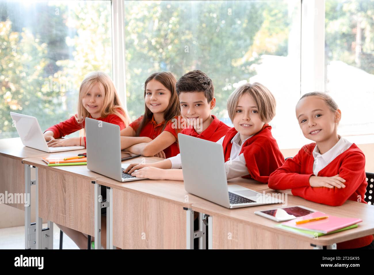 Little children studying with laptops at school computer lab Stock ...