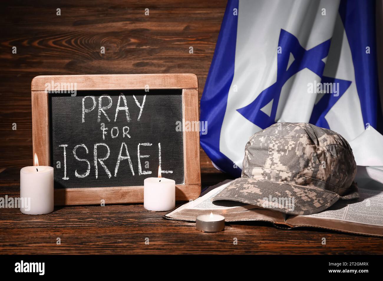 Chalkboard with text PRAY FOR ISRAEL, candles, military cap, Torah and ...