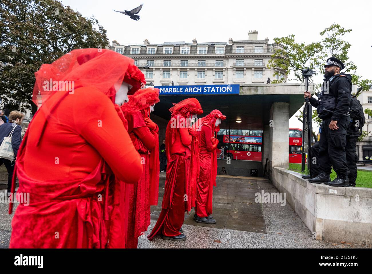 London, UK. 19 October 2023. Red Rebels interact with police officers ...