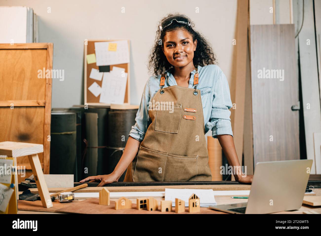 black woman curly hair carpenter smile working in carpentry DIY on ...