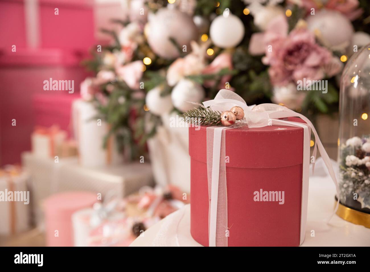 Beautiful Christmas gift boxes on floor near fir tree in room Stock ...