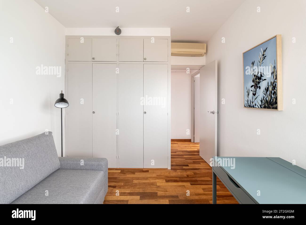 Restored room with wardrobe sofa and table in apartment Stock Photo - Alamy