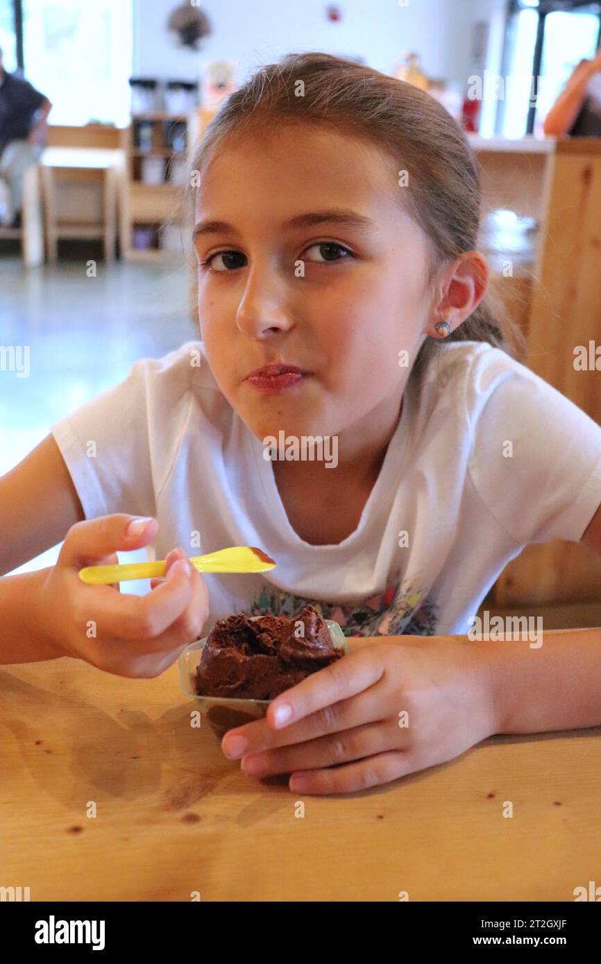 Girl Savoring Bowl of Chocolate Gelato Stock Photo - Alamy