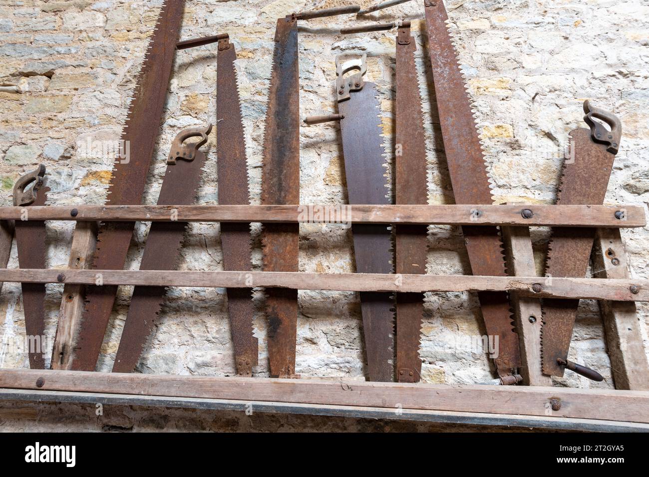 Photo of a selection of antique farm tools inside the barn atTyneham ...