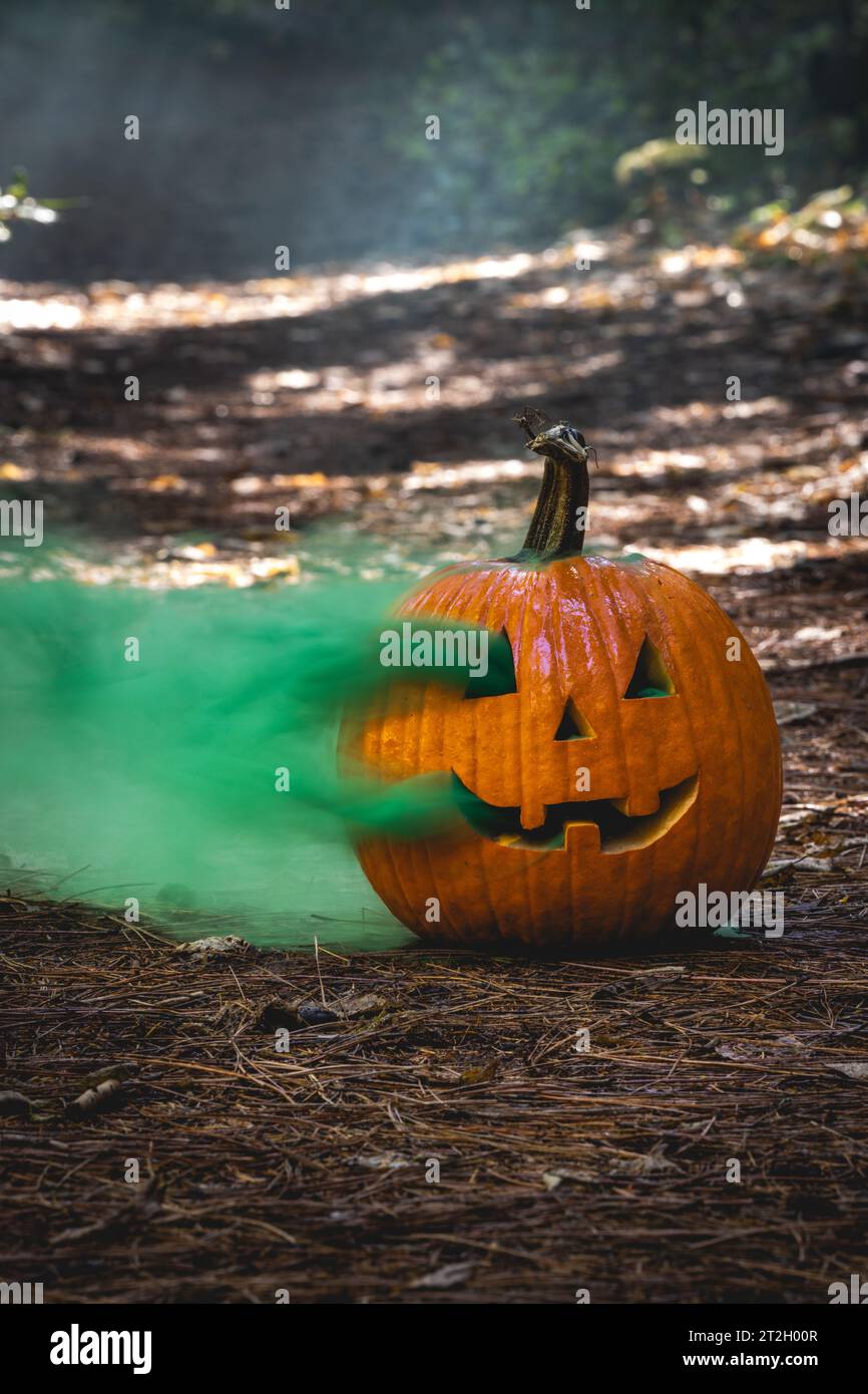 close up of a carved pumpkin for halloween with smoke coming out of the ...