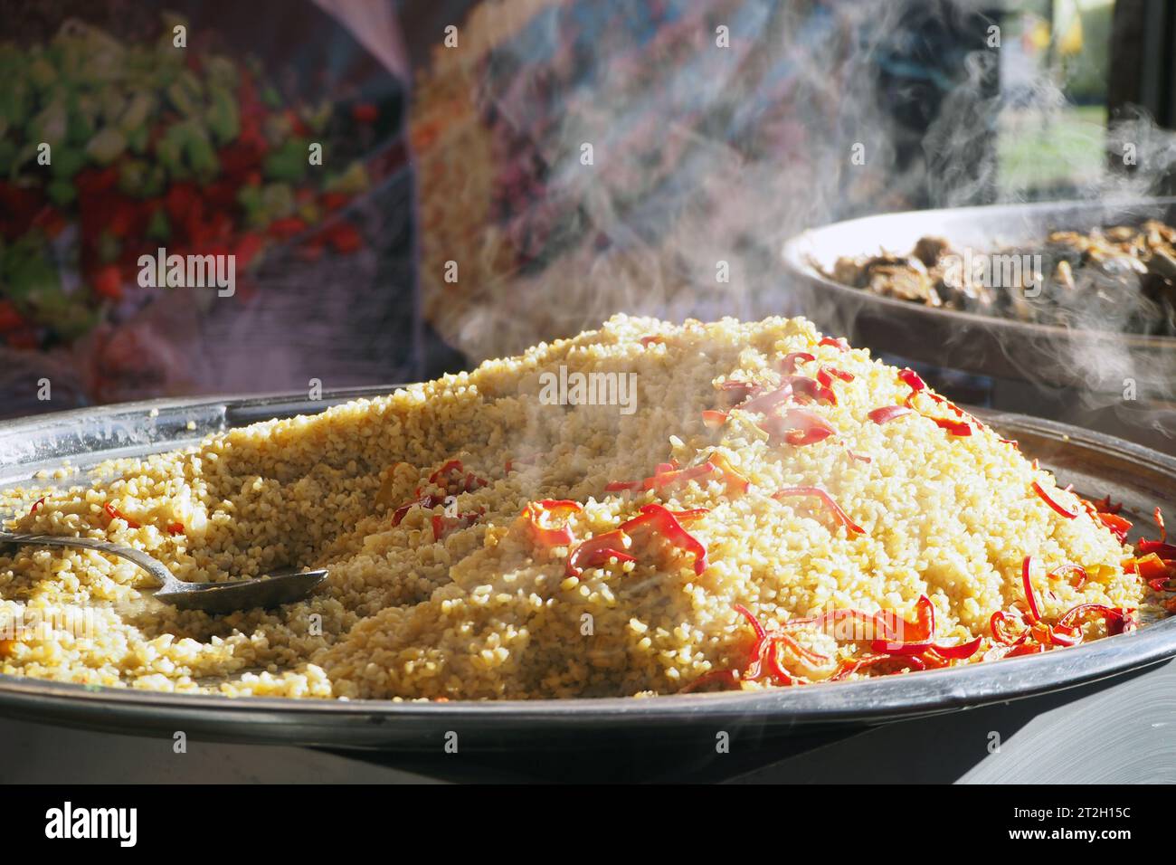Freshly baked bulgur pilaf. Smoke over bulgur rice on large tray Stock ...