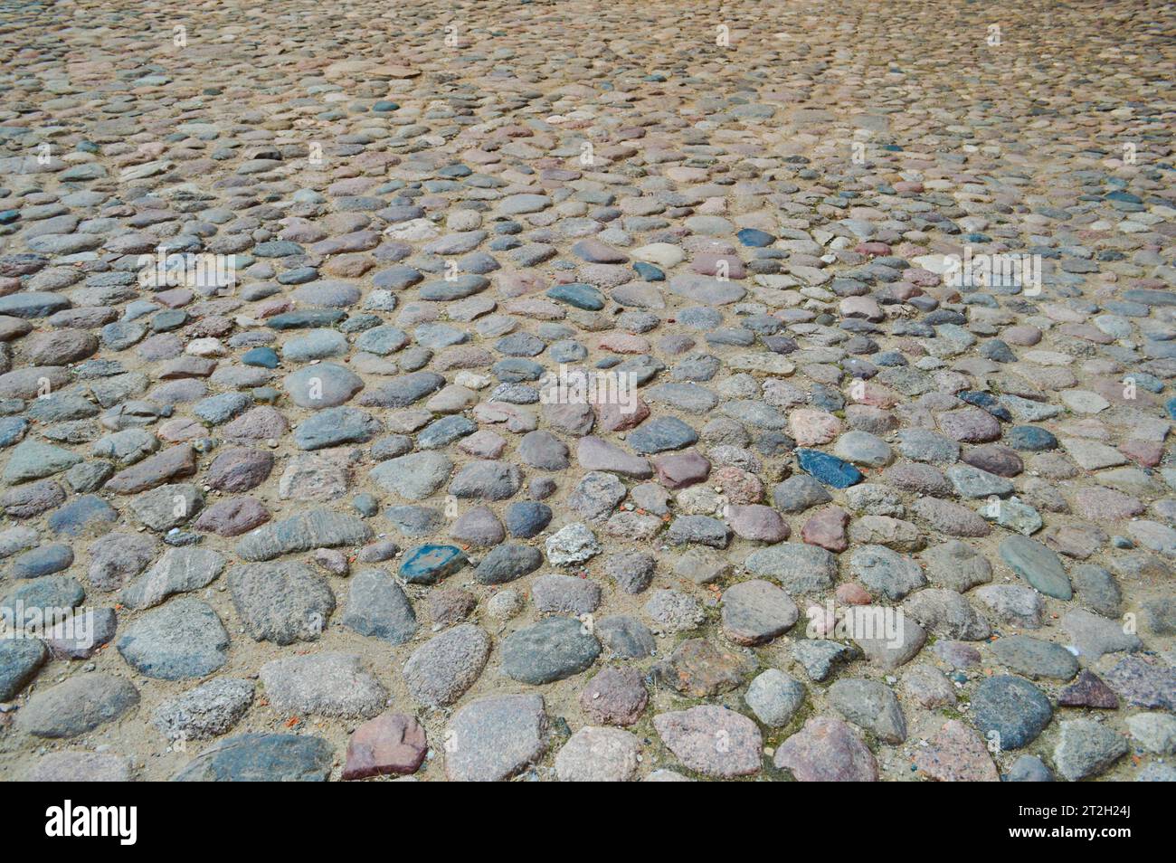 The texture of the stone road, pavement, walls of large gray old ...