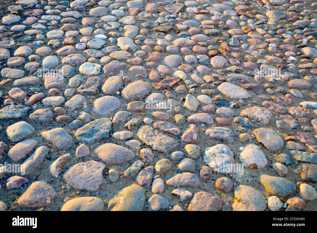 The texture of the stone road, pavement, walls of large gray old ...