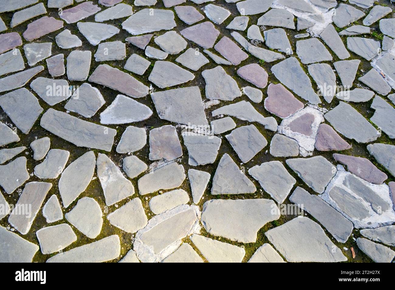 The texture of the stone road, pavement, walls of large gray old ...