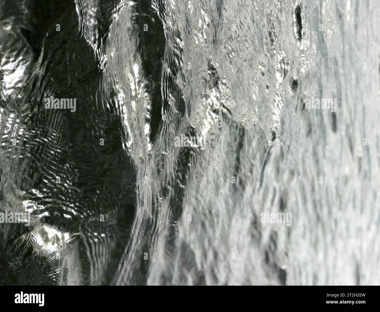 A wall of dark black cold water with waves of ripples rippling. The ...