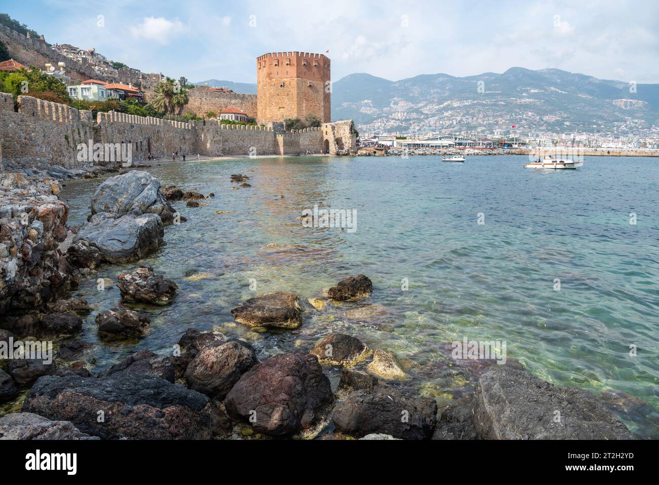 View toward old harbour walls and Red Tower in Alanya, Turkey. The five ...