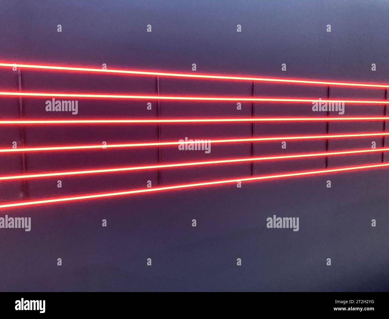 neon stripes, illumination. stripes of red on a black ceiling. bright ...