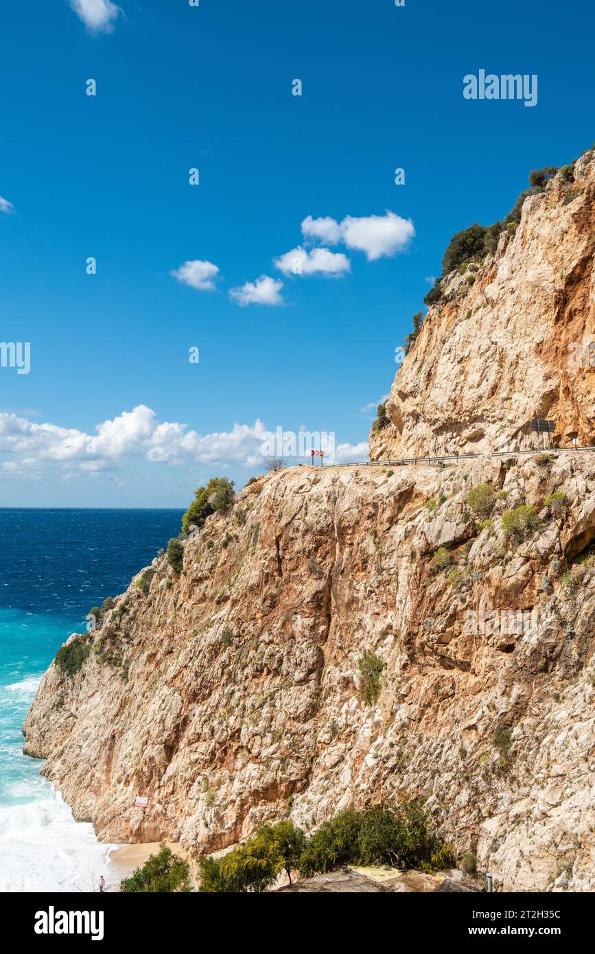 Sheer cliff with a road cut through on the Mediterranean coastline ...
