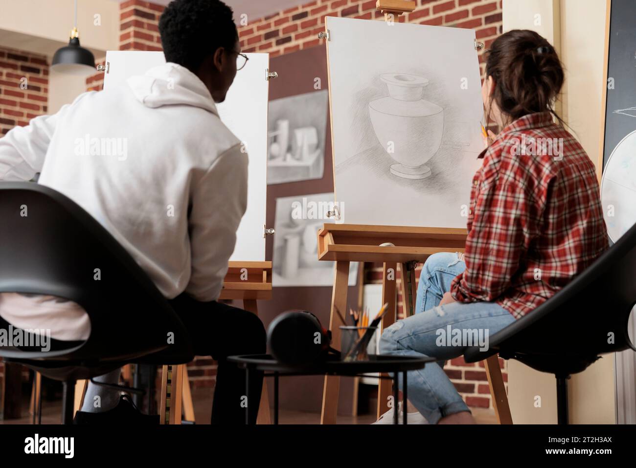 Young diverse people students looking at canvas with vase sketch ...