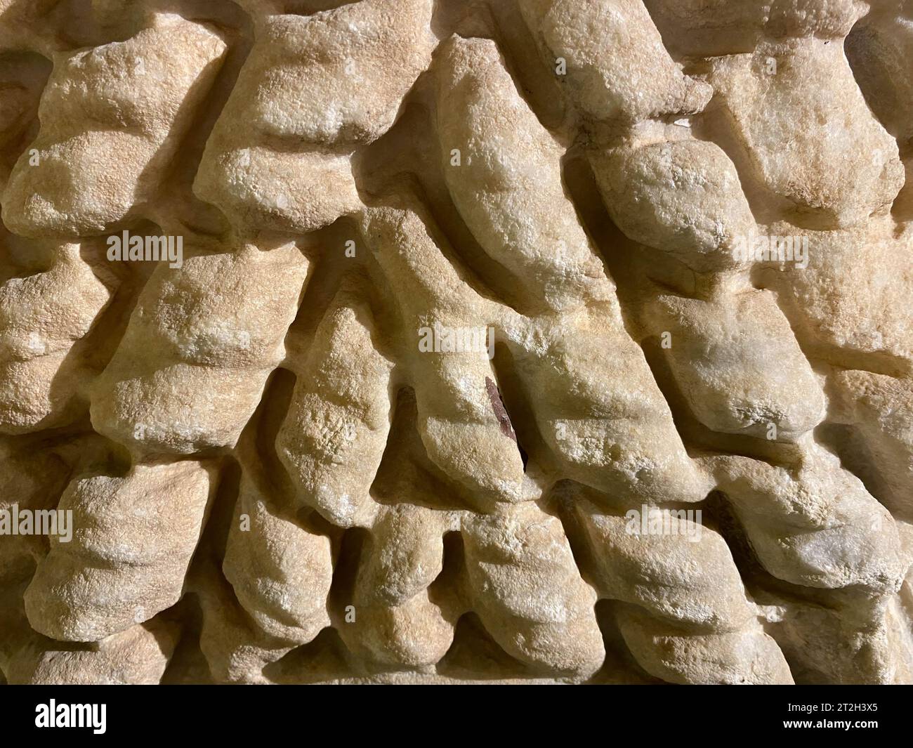 Photo of an old rough stone wall with bulging, rough growths Stock ...