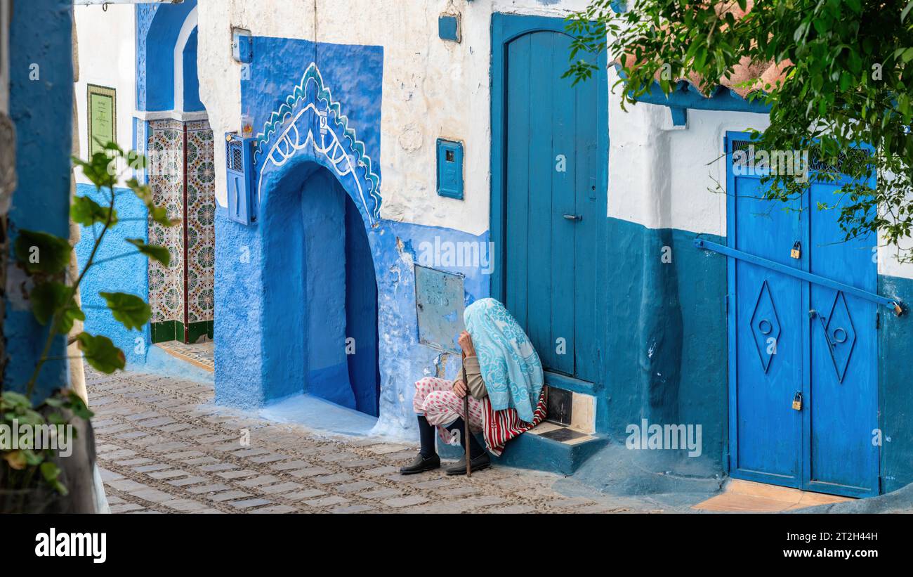 Chefchaouen, Morocco - 11 September 2022: Old woman sitting by her ...