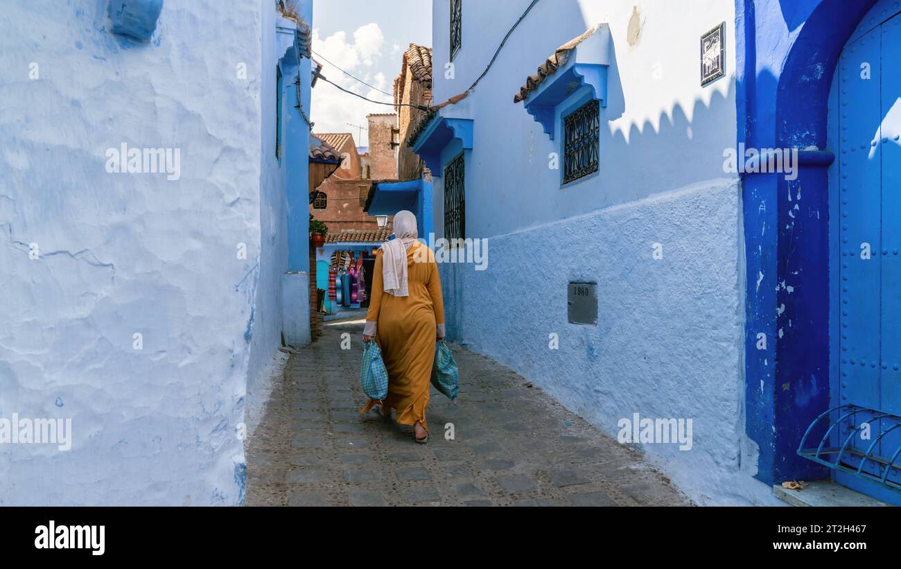 Chefchaouen, Morocco - 11 September 2022: Woman walking in Chefchaouen ...
