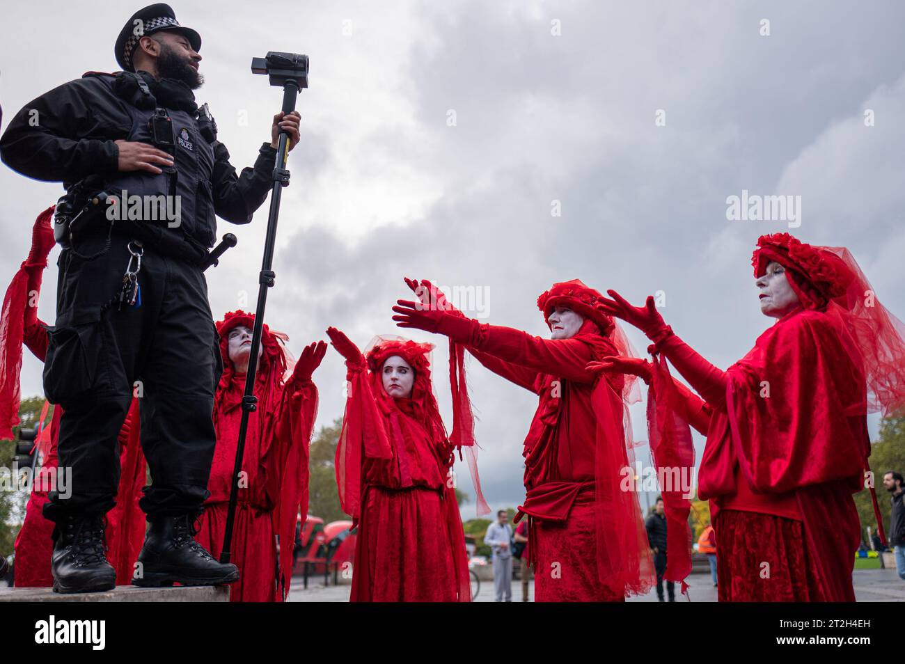 London, UK. 19th Oct, 2023. Red Rebels join climate activists during an ...