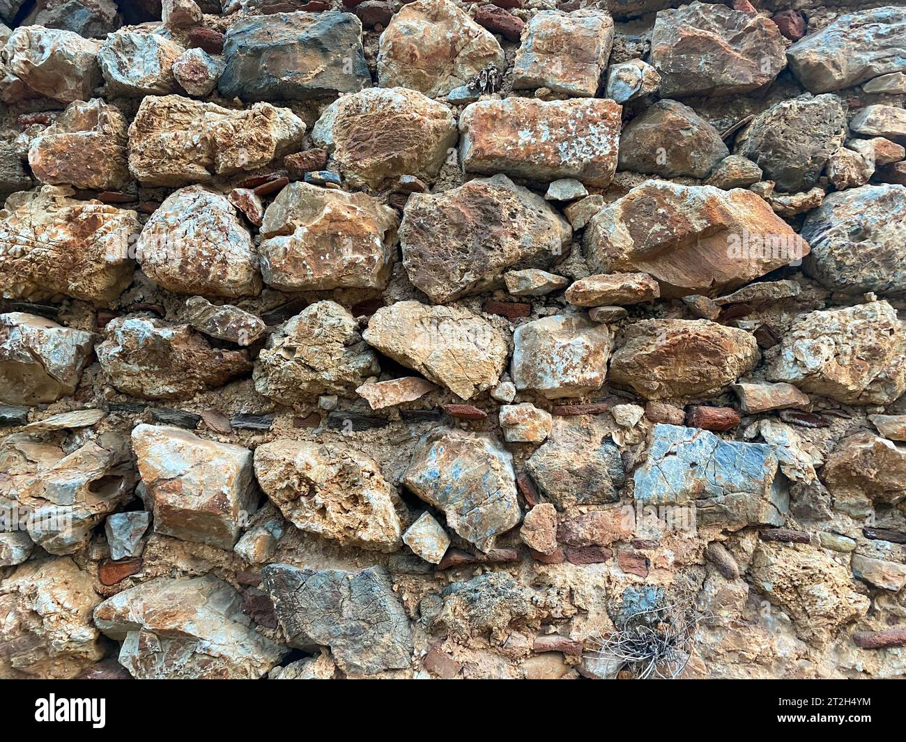 Background, texture, stone wall of round stones cobblestones bricks ...