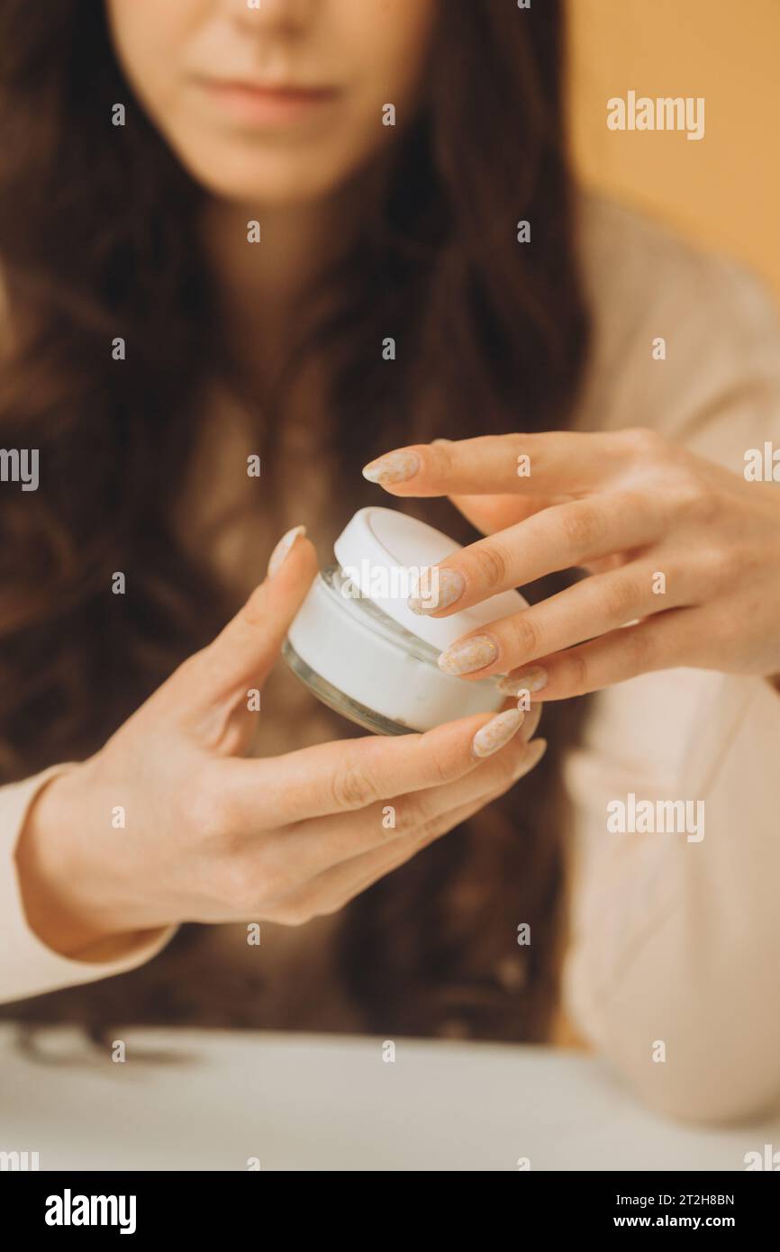 Portrait of attractive healthy girl using daily collagen cream flawless ...