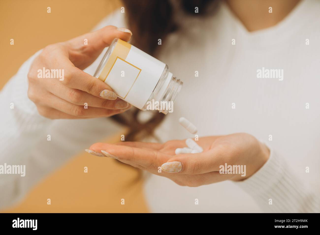 close up person pouring multivitamin capsules to her hands Stock Photo ...