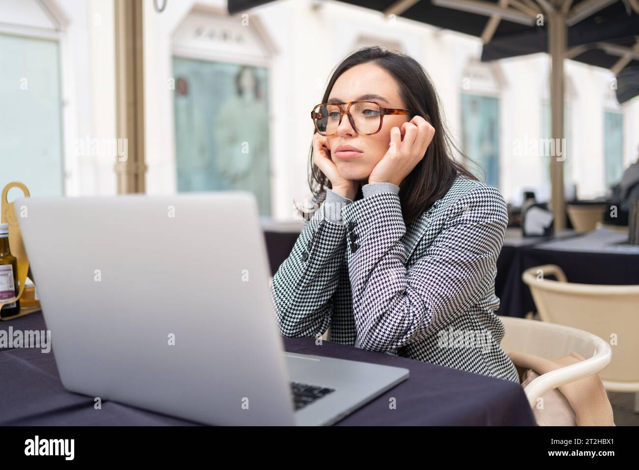 Bored inefficient woman office employee using laptop sitting at ...