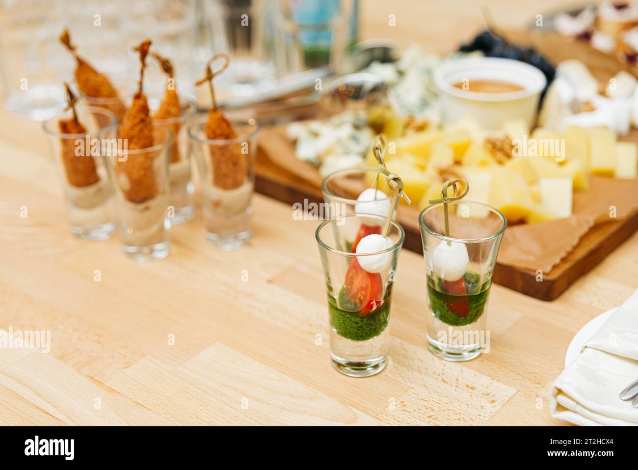 catering, food and drinks concept - close up of different appetizers in ...