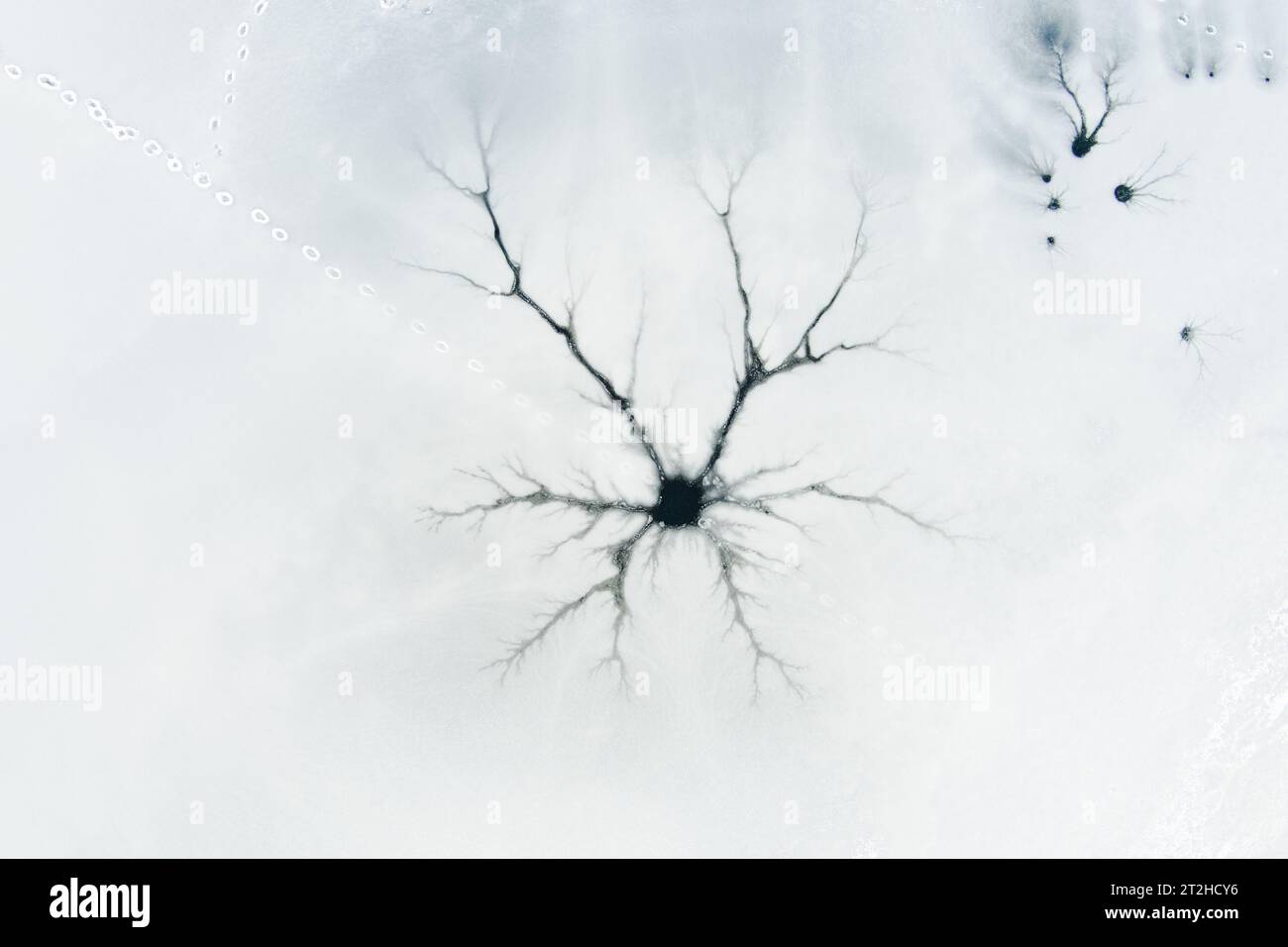 Aerial top-down winter view of frozen lake surface, ice texture with ...