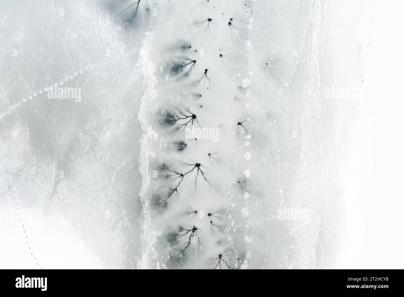 Aerial top-down winter view of frozen lake surface, ice texture with ...
