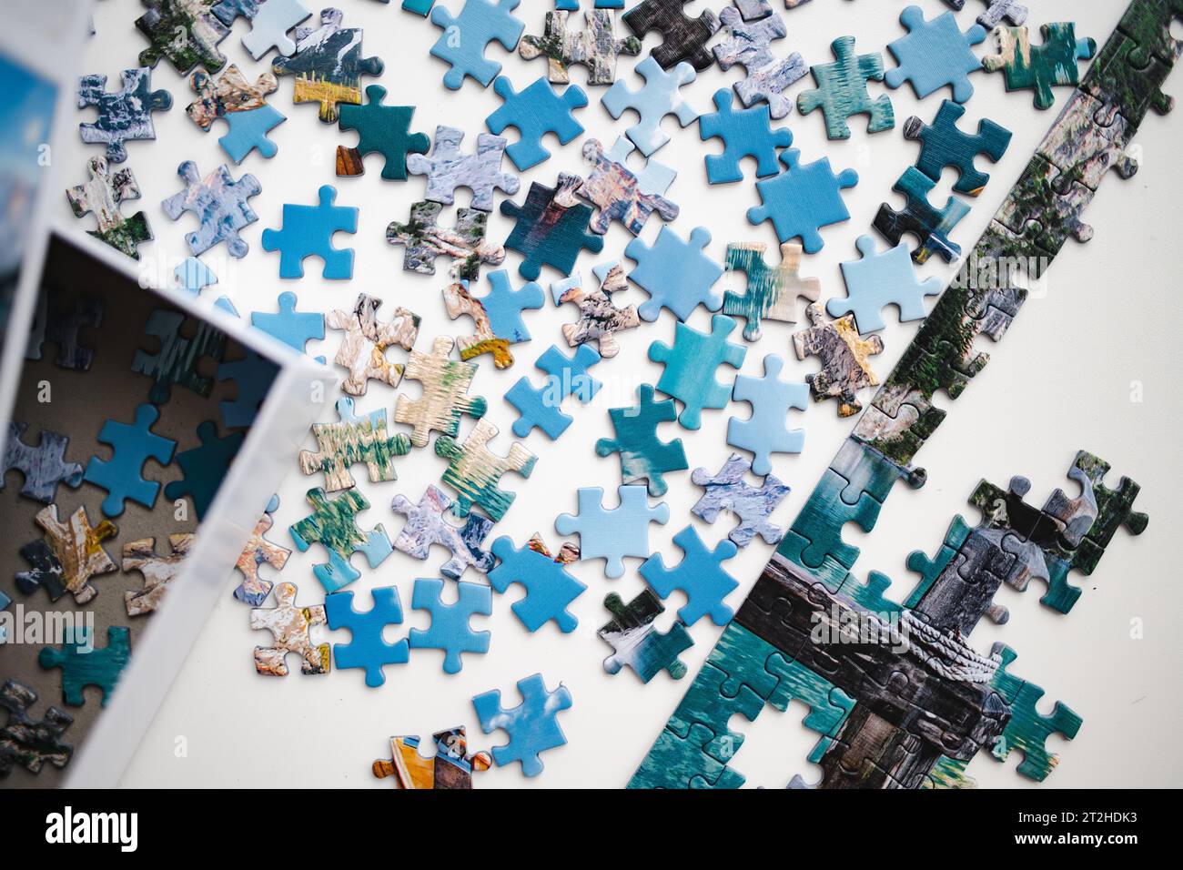 Playing puzzles at home. Connecting jigsaw puzzle pieces in a living ...