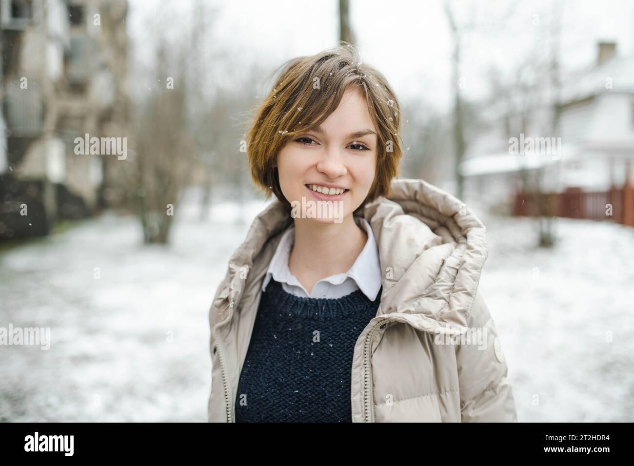 Cute teen girl having fun on a walk in city park on chilly winter day ...