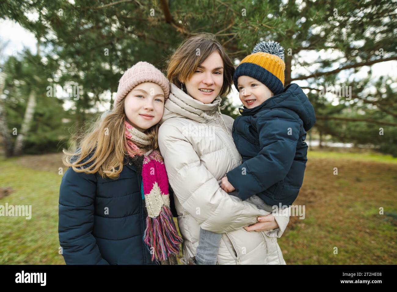 Two big sisters and their toddler brother having fun outdoors. Two ...