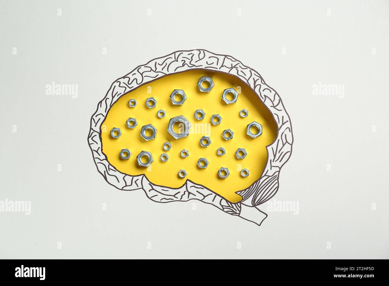 Analytical thinking. Nuts on yellow background, top view through paper ...