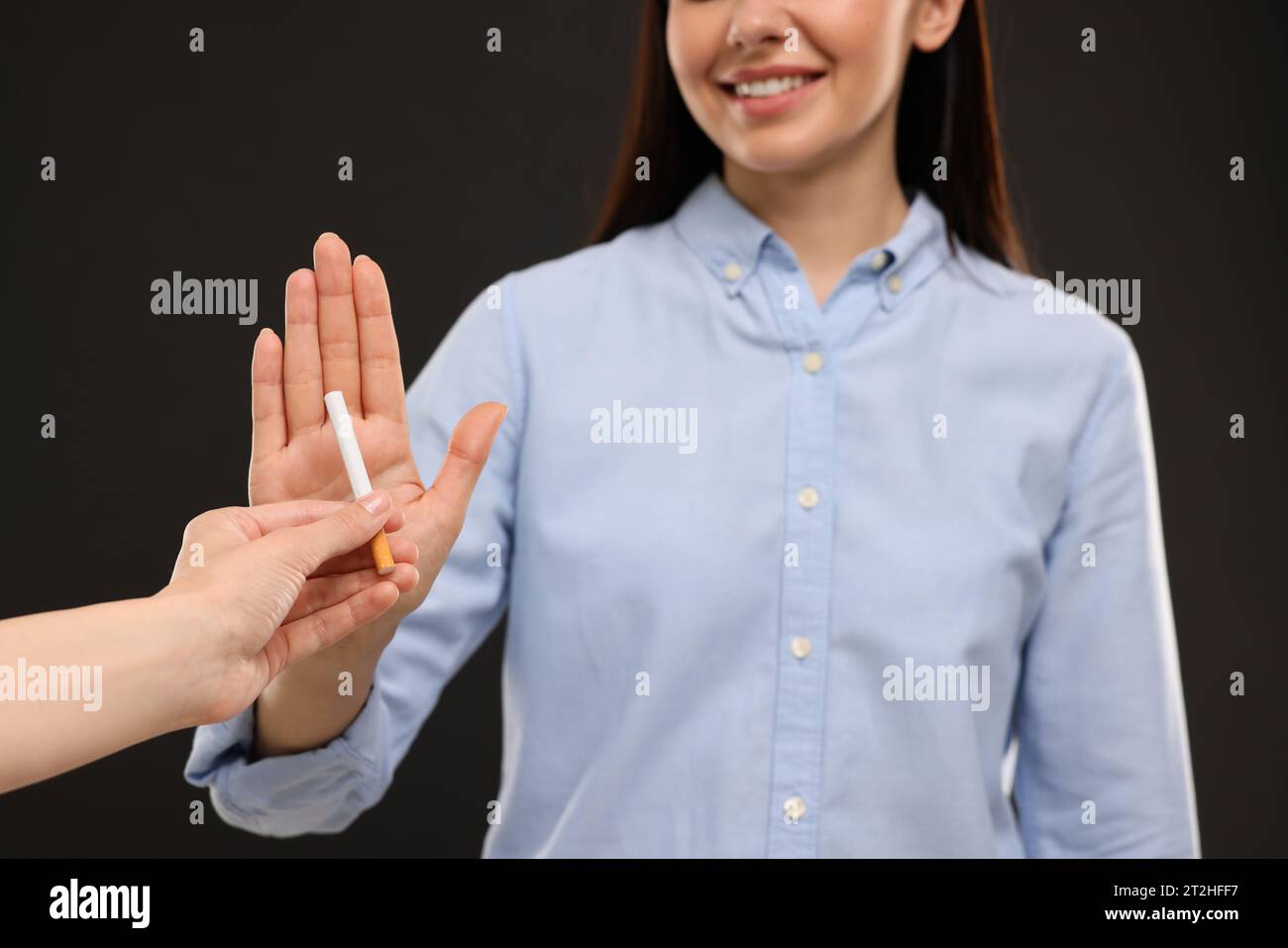 Stop smoking concept. Woman refusing cigarette on black background ...
