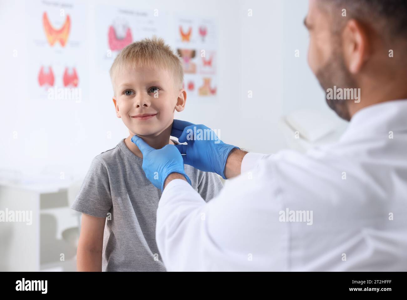 Endocrinologist examining boy's thyroid gland at hospital Stock Photo ...