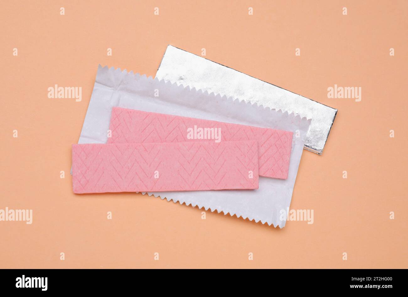 Sticks of tasty chewing gum on coral background, flat lay Stock Photo ...