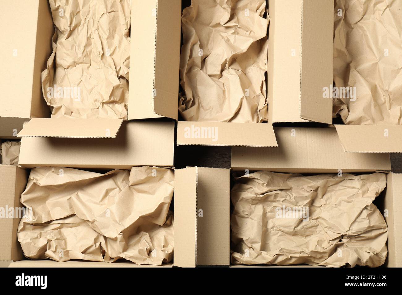 Open cardboard boxes with crumpled paper, top view. Packaging goods ...