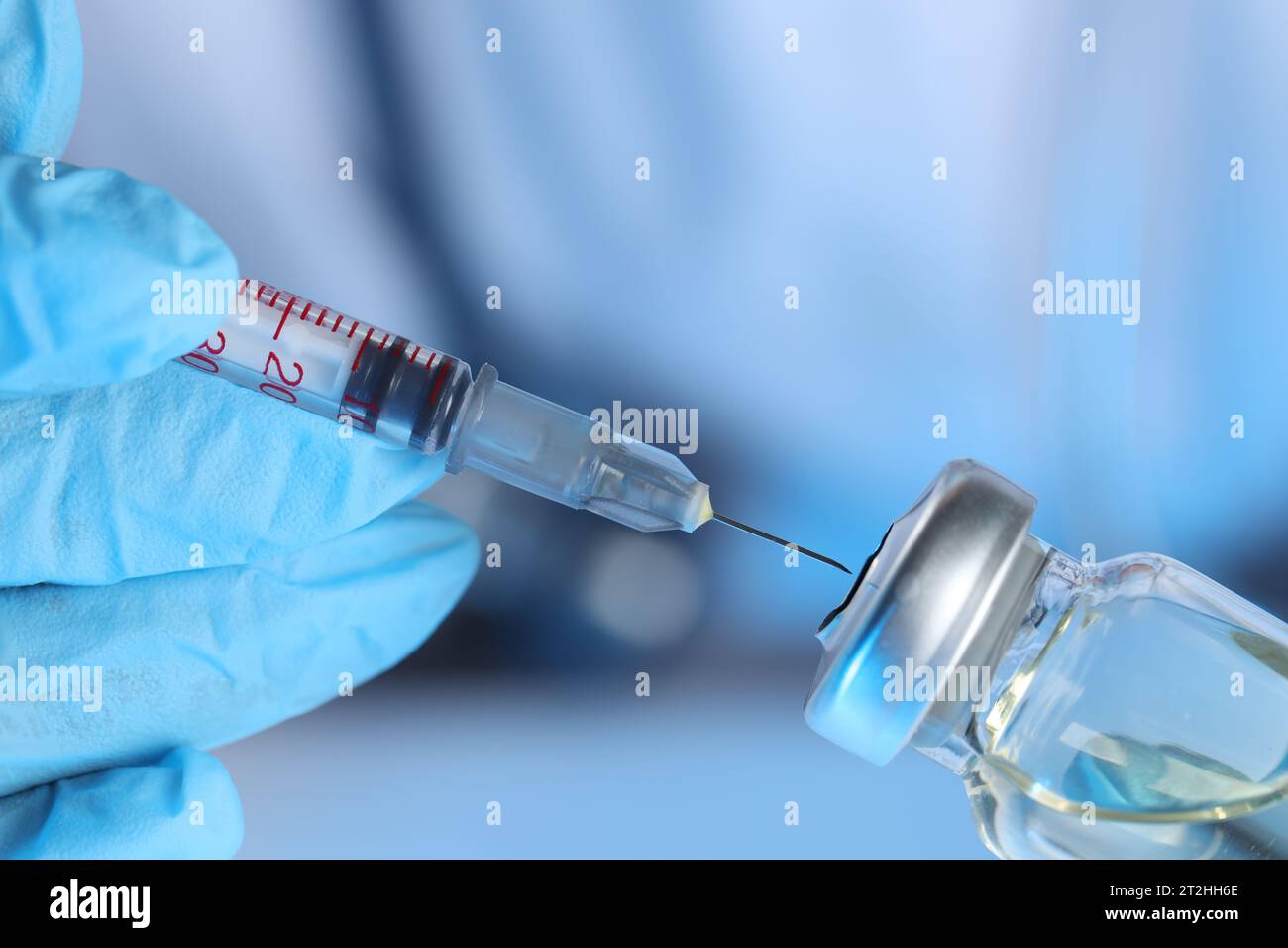 Doctor inserting syringe into glass vial with medication, closeup Stock ...