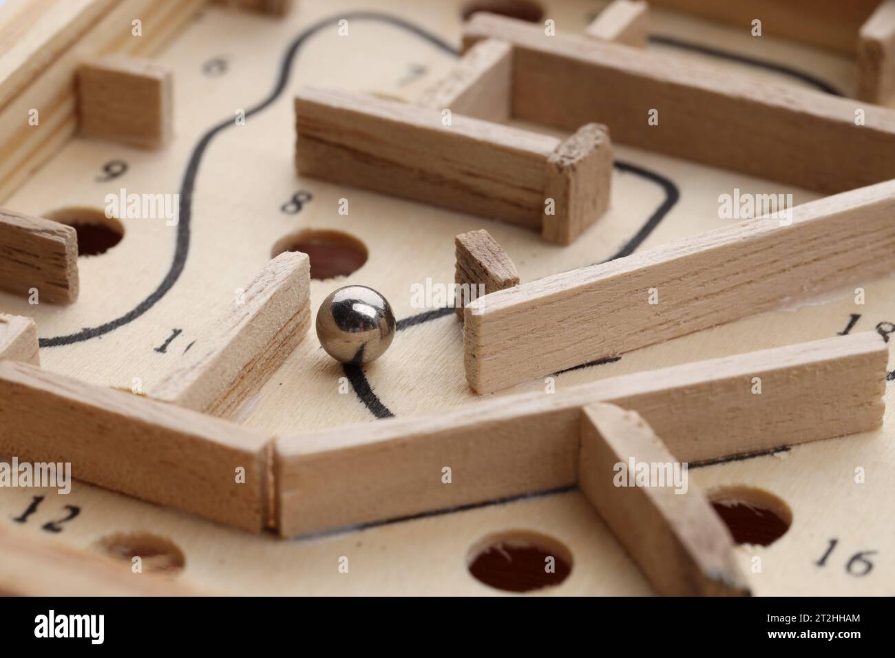 Wooden toy maze with metal ball, closeup Stock Photo - Alamy