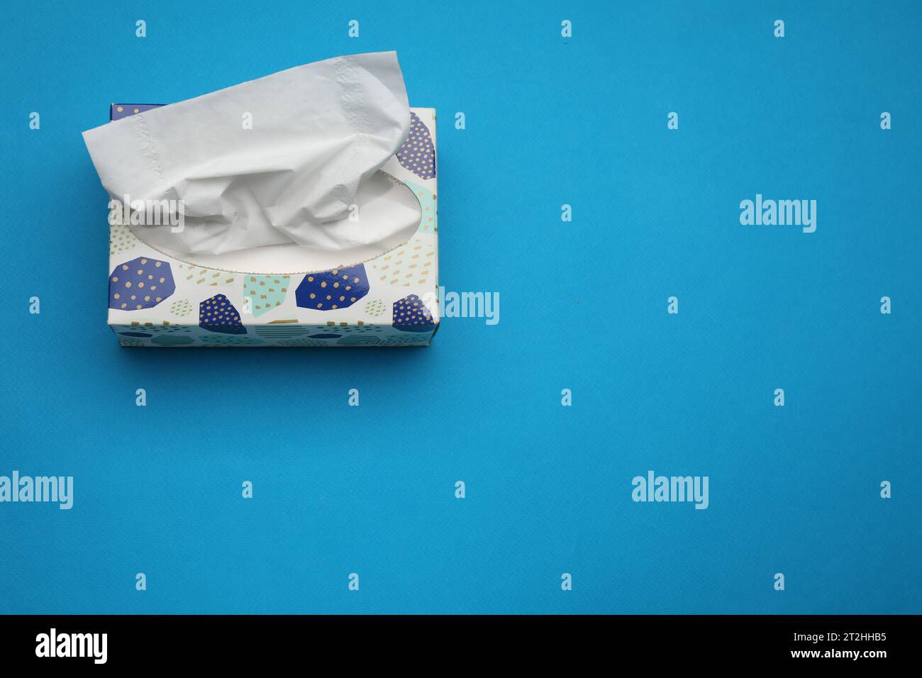 Box of paper tissues on light blue background, above view. Space for ...