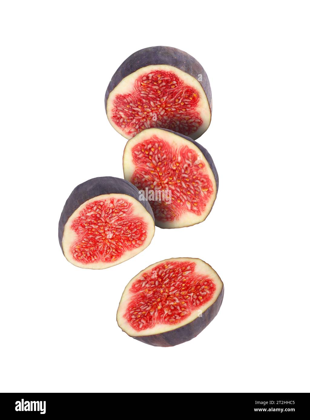 Halved fresh figs falling on white background Stock Photo - Alamy