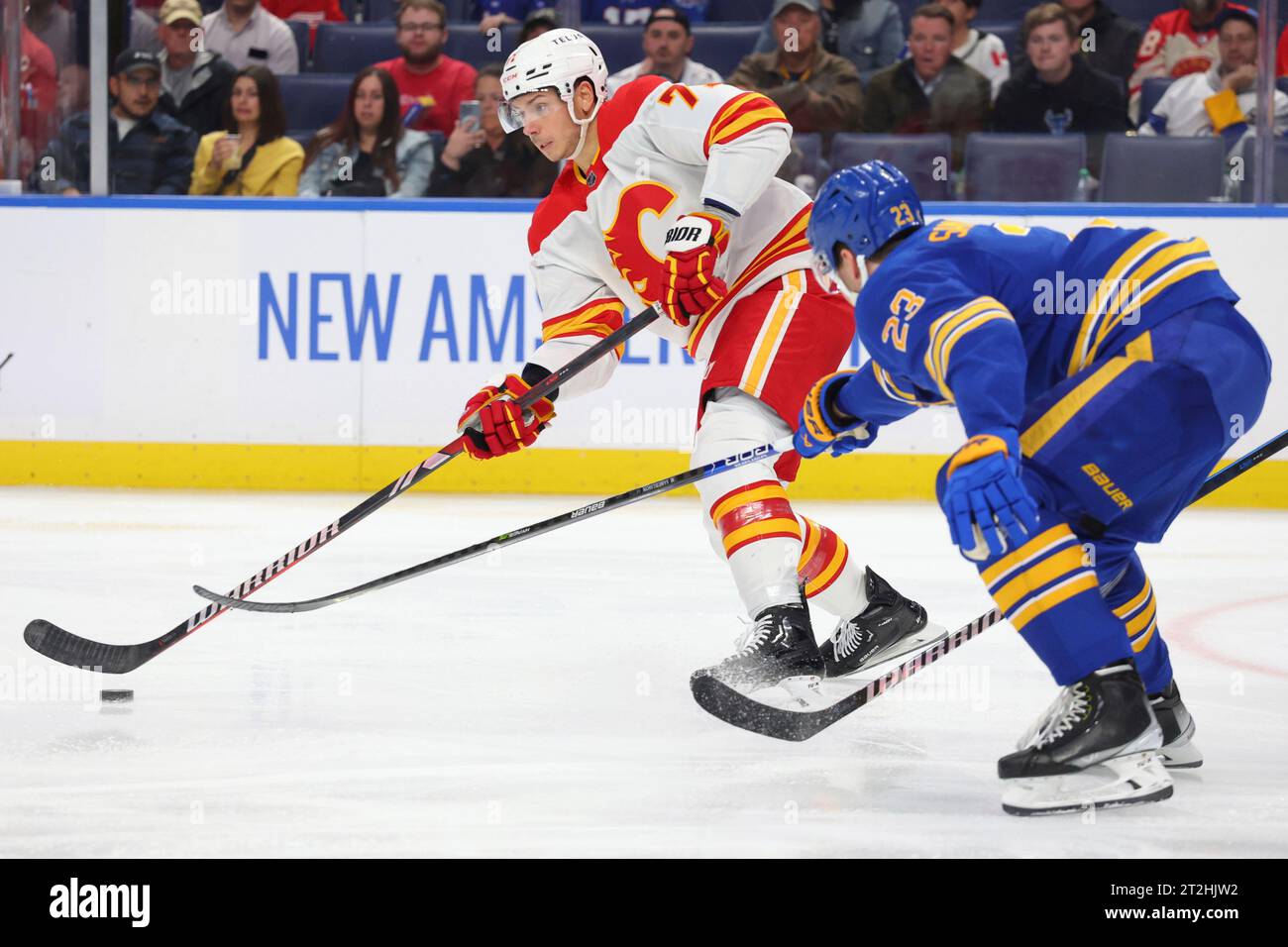 Calgary Flames center Walker Duehr (71) is stick checked by Buffalo ...