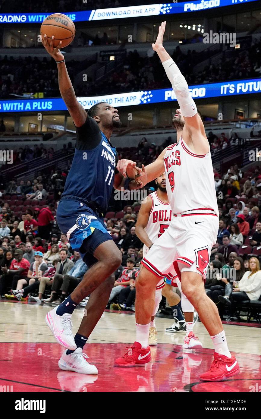 Minnesota Timberwolves center Naz Reid, left, drives to the basket ...