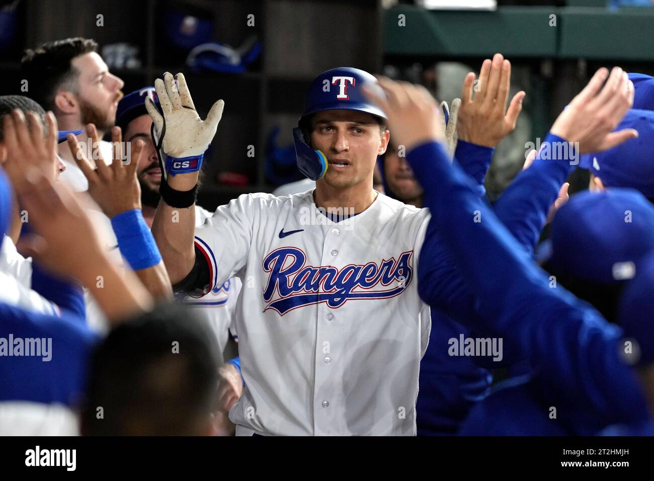 Texas Rangers' Corey Seager celebrates in the dugout after hitting a ...