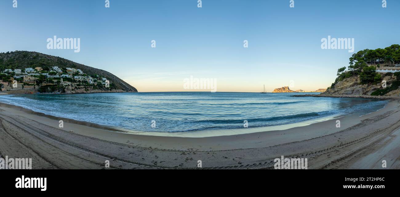 Panoramic view of empty El Portet beach in Moraira overlooking Ifach ...