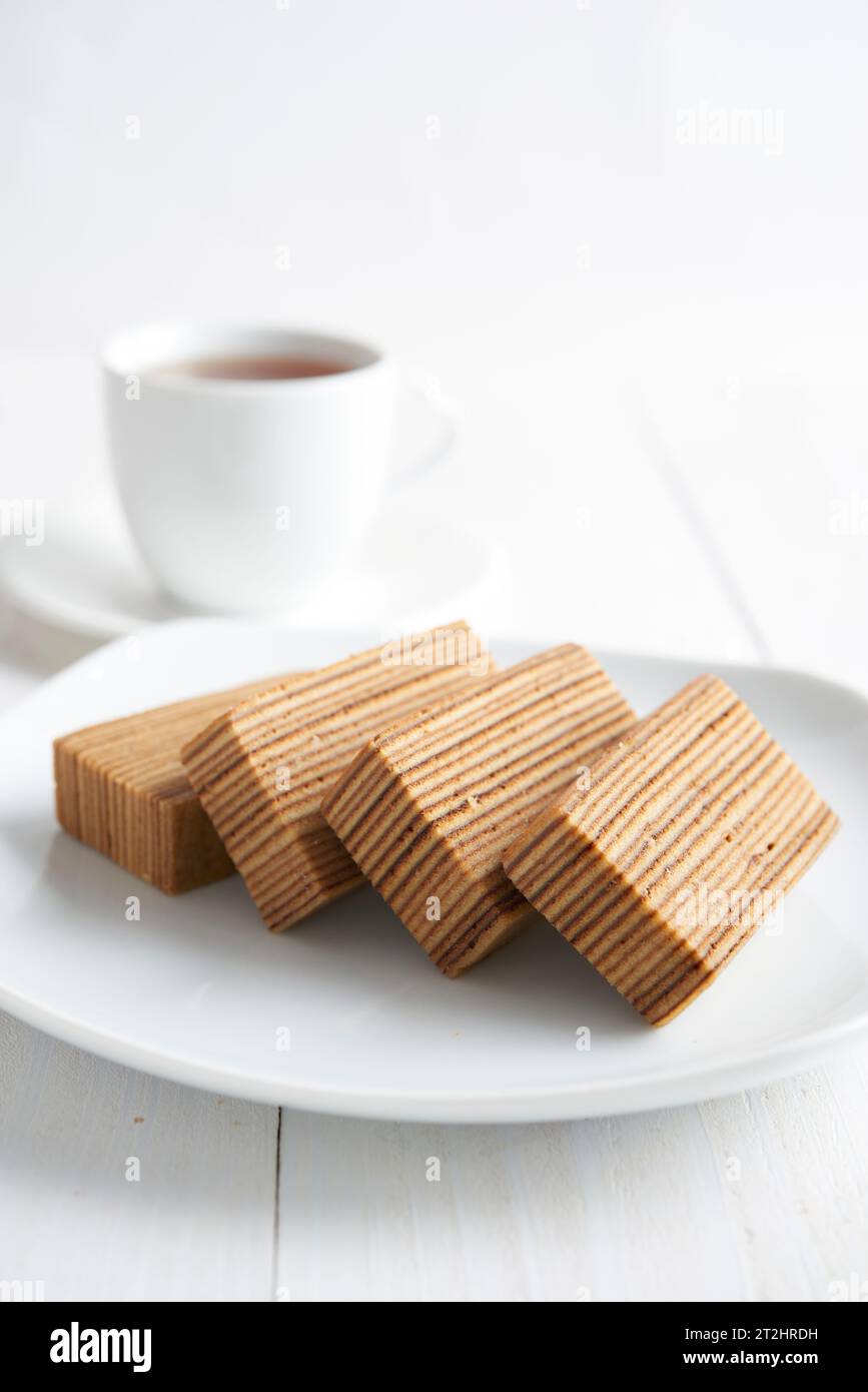 traditional indonesian kek lapis (layered cake) and a cup of coffee ...