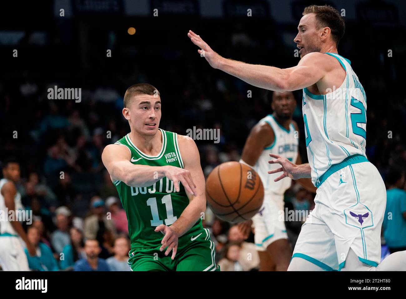 Boston Celtics guard Payton Pritchard, left, makes a pass under ...