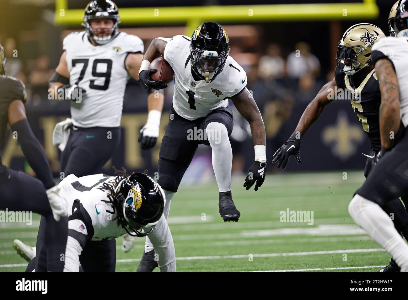 Jacksonville Jaguars running back Travis Etienne Jr. (1) jumps past New ...